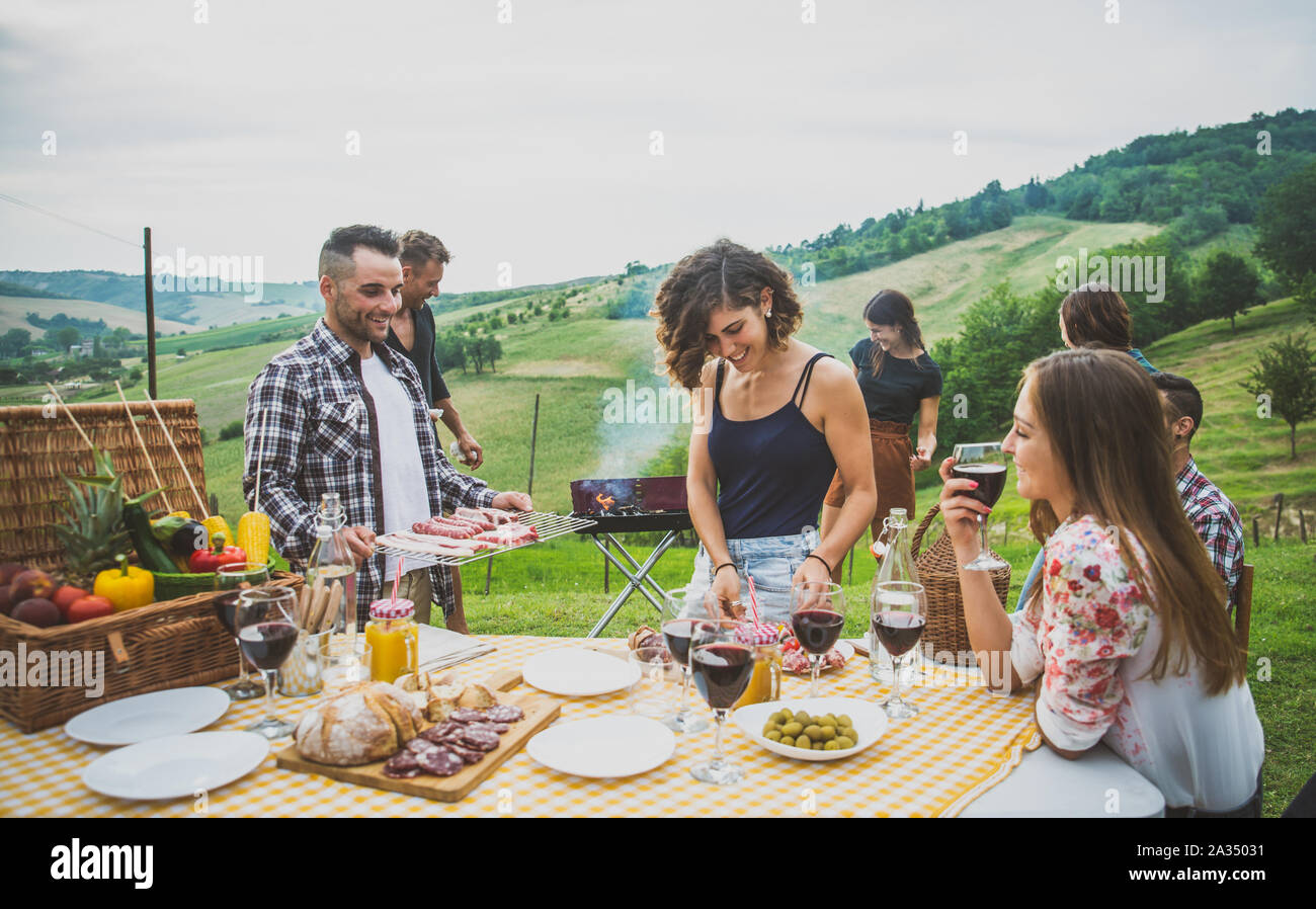 Group of friends spending time making a picnic and a barbeque Stock ...