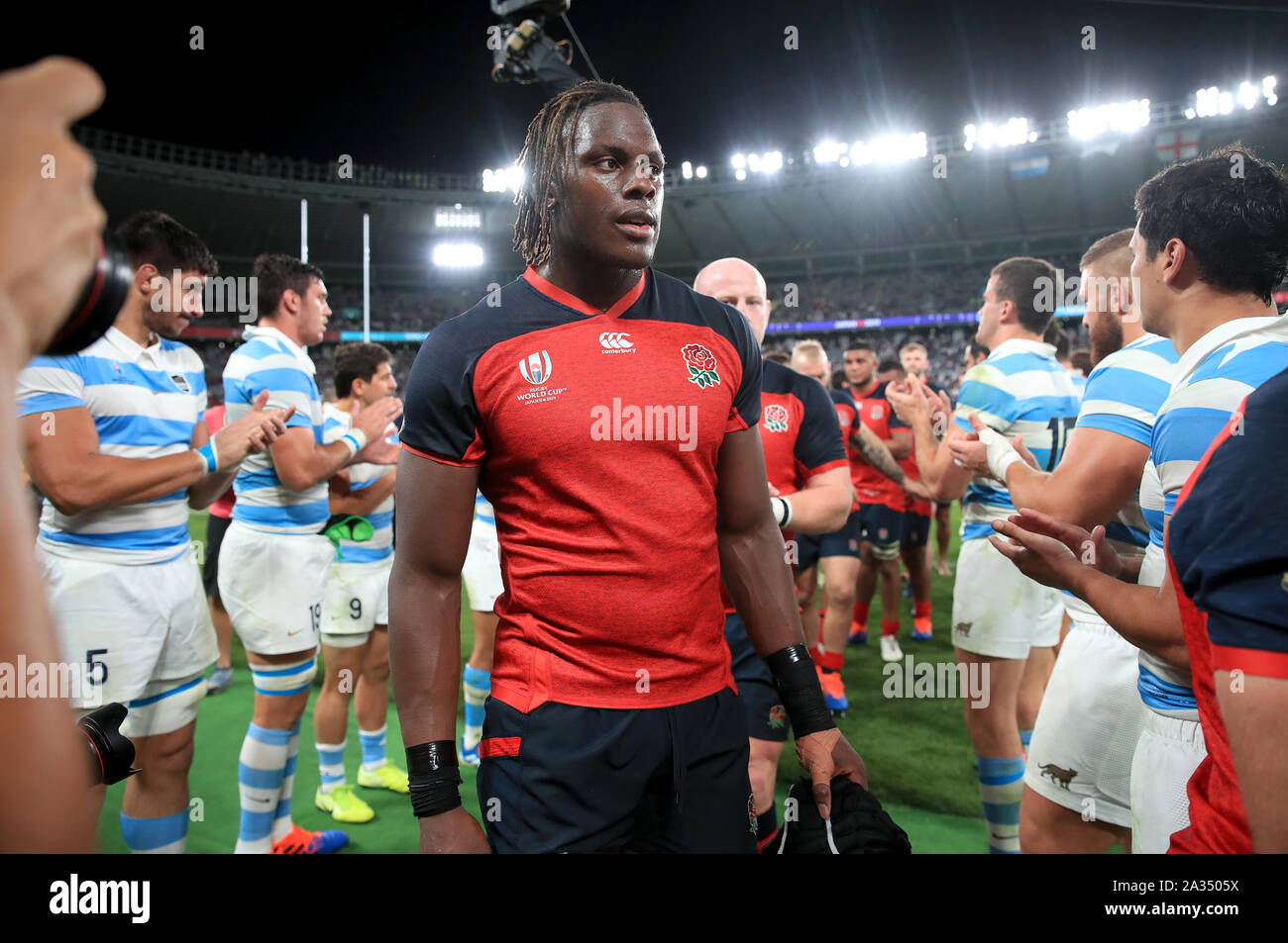 England's Maro Itoje and his team-mates leave the pitch through a guard ...