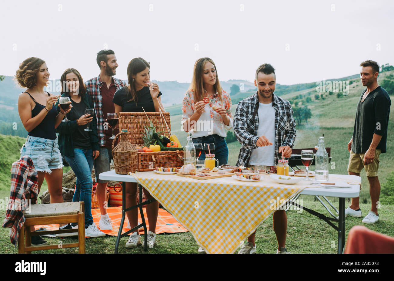 Group of friends spending time making a picnic and a barbeque Stock ...