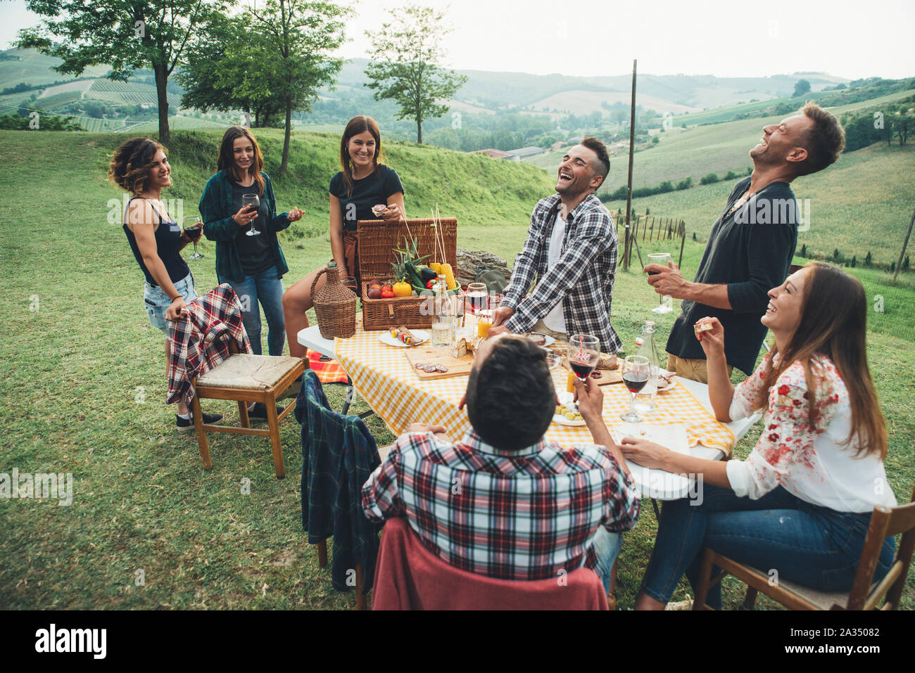 Group of friends spending time making a picnic and a barbeque Stock ...