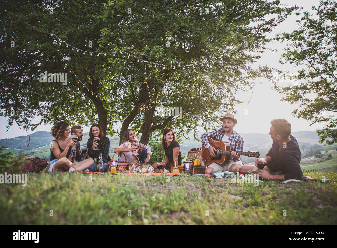 Group of friends spending time making a picnic and a barbeque Stock ...