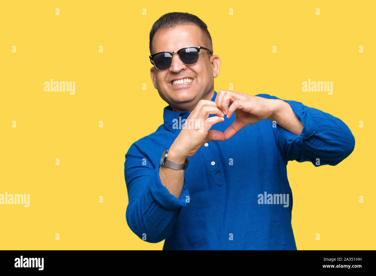 Middle age arab man wearing sunglasses over isolated background smiling ...