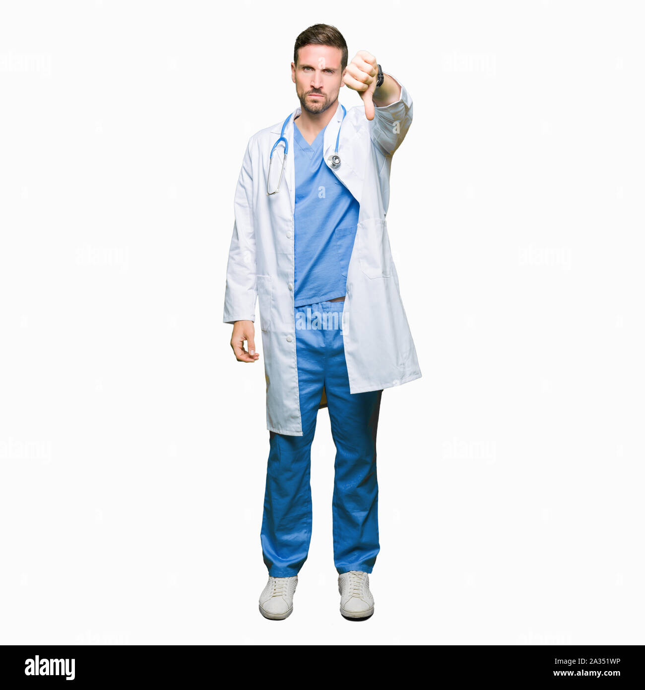 Handsome doctor man wearing medical uniform over isolated background ...