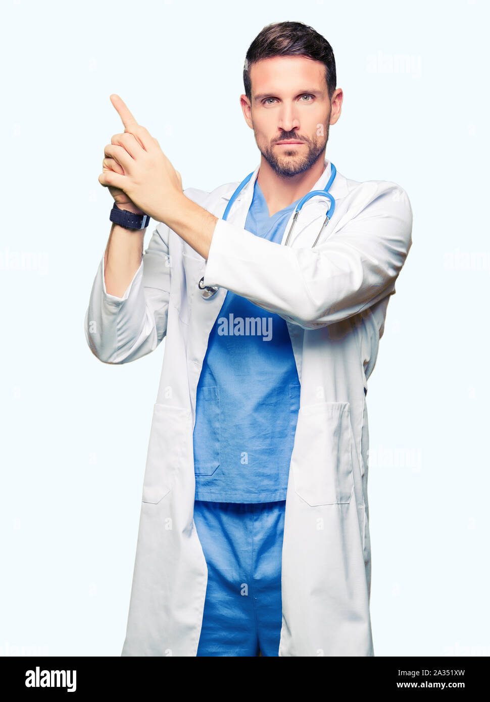 Handsome doctor man wearing medical uniform over isolated background ...