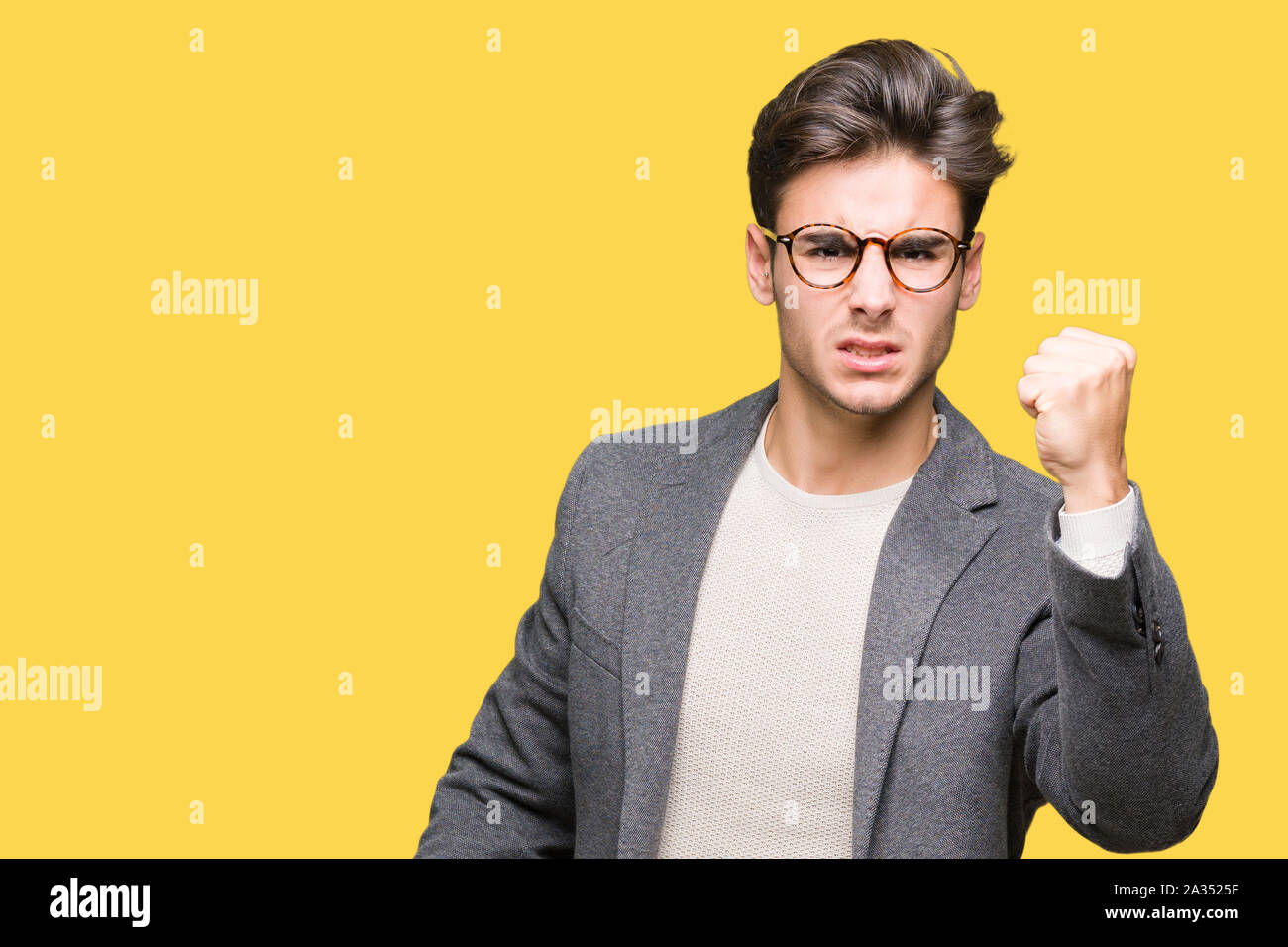 Young business man wearing glasses over isolated background angry and ...