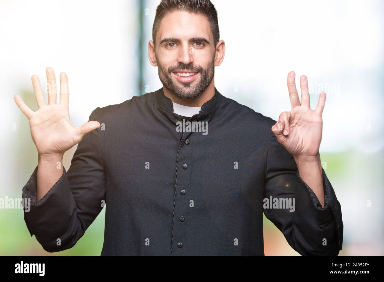Young Christian priest over isolated background showing and pointing up ...