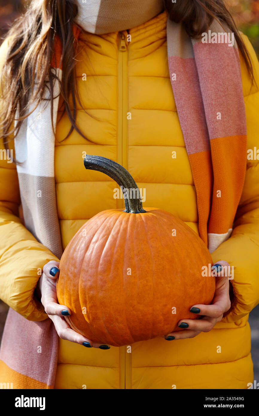 Woman holding orange pumpkin, fall concept Stock Photo - Alamy