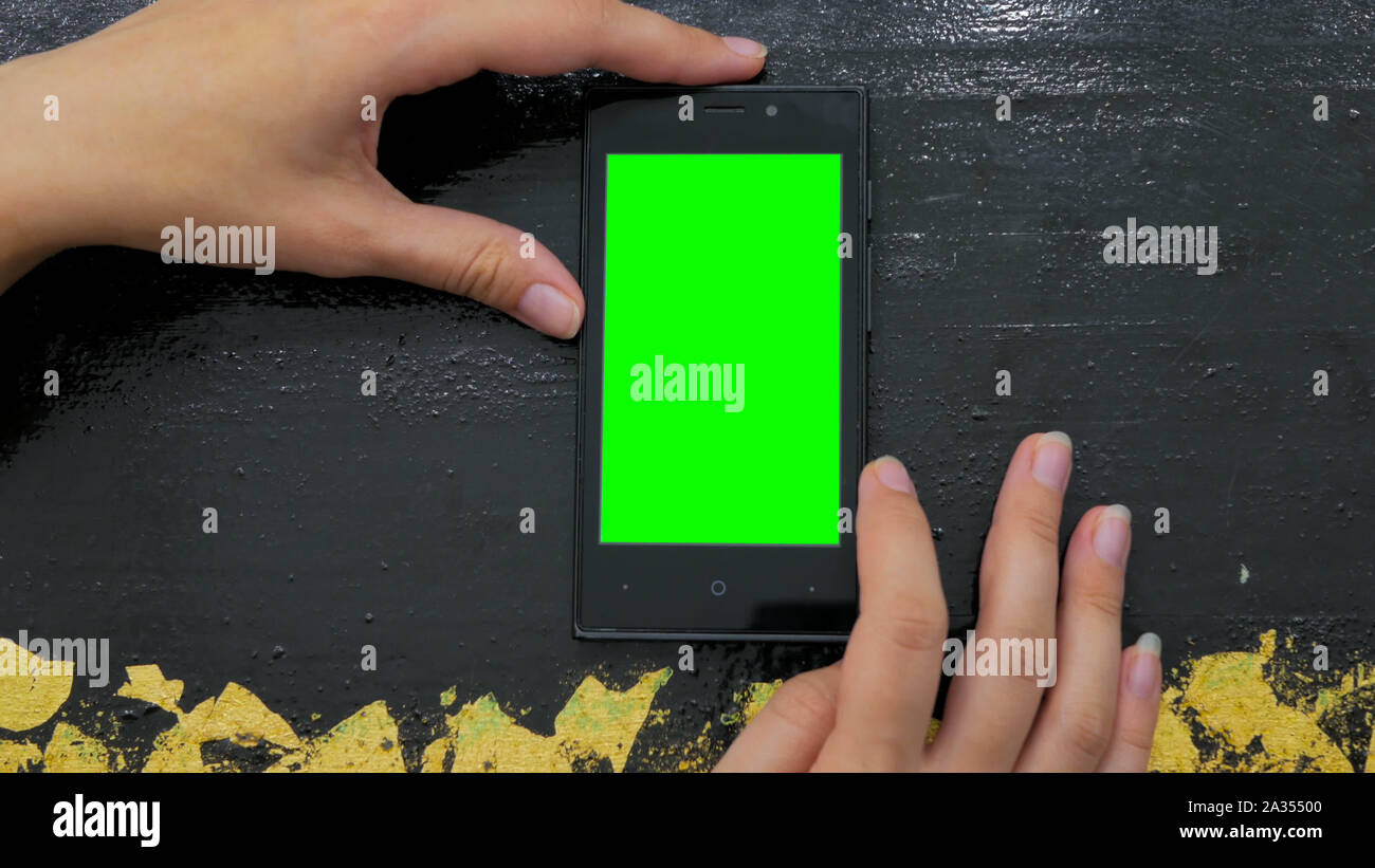 Woman using smartphone with green screen Stock Photo - Alamy