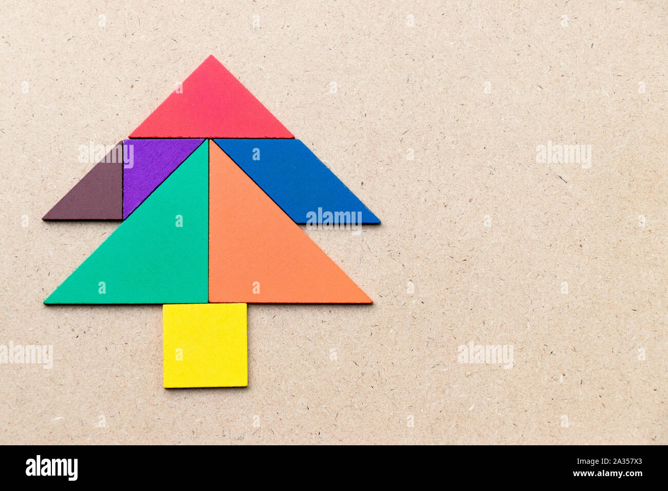 Color tangram in Pine or christmas tree shape on wood background Stock ...