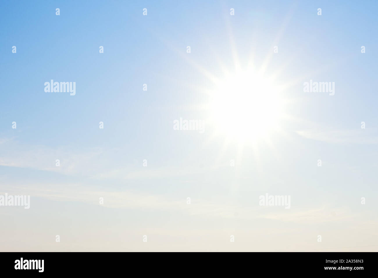 bright but calm sun on a light blue sky, muted colors, good background ...