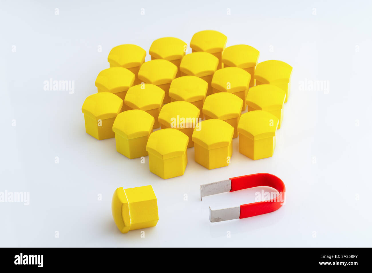 colored caps for automotive nuts or bolts, yellow. Close up white ...