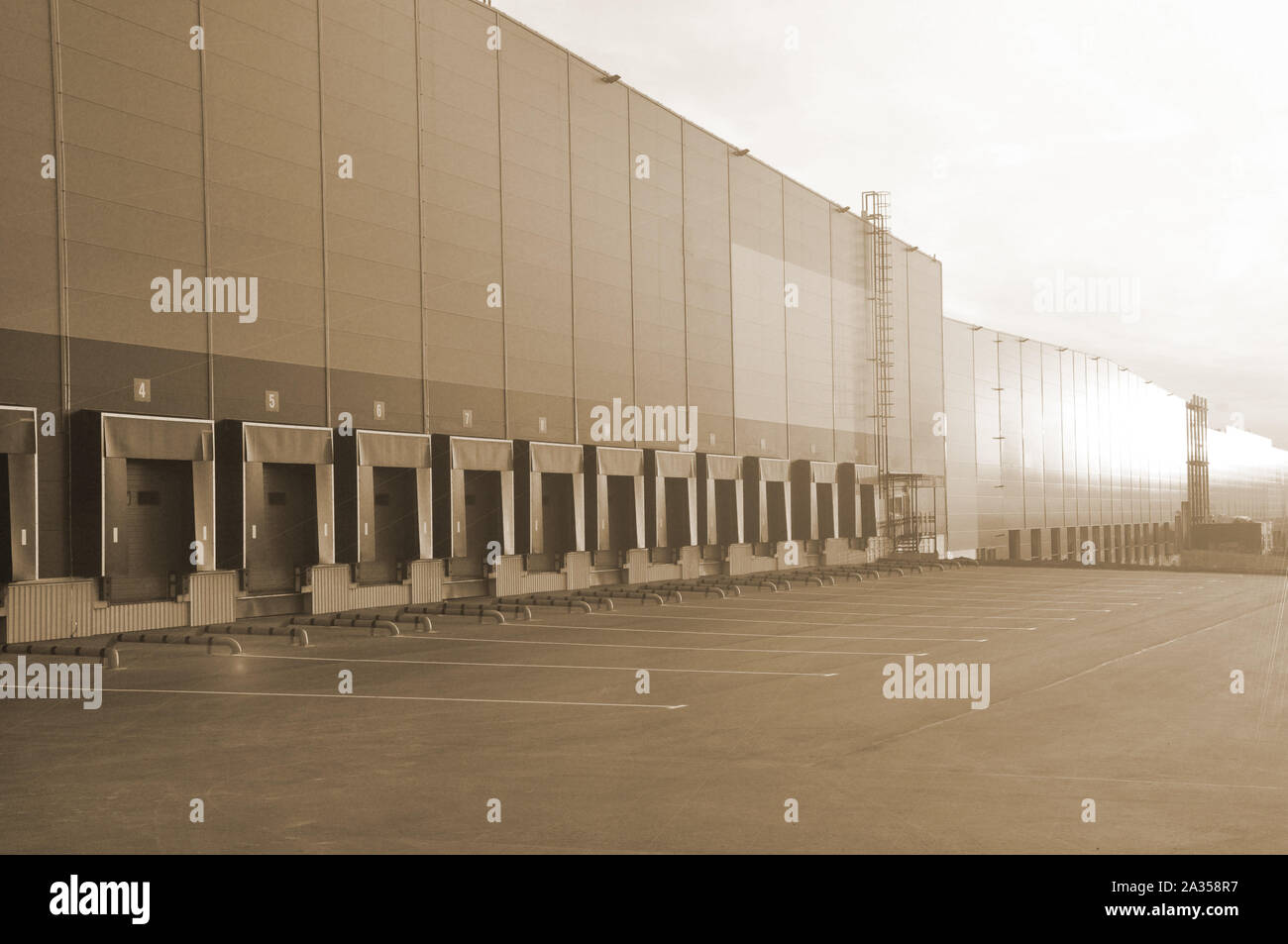 Modern warehouse complex. View of loading docks in the rays of the ...