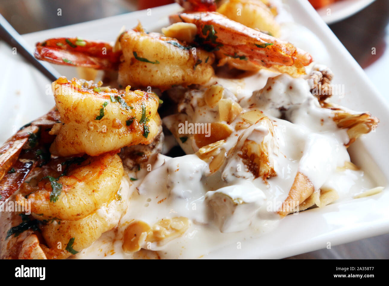 Traditional Lebanese grilled prawns with garlic yoghurt fatteh Stock ...