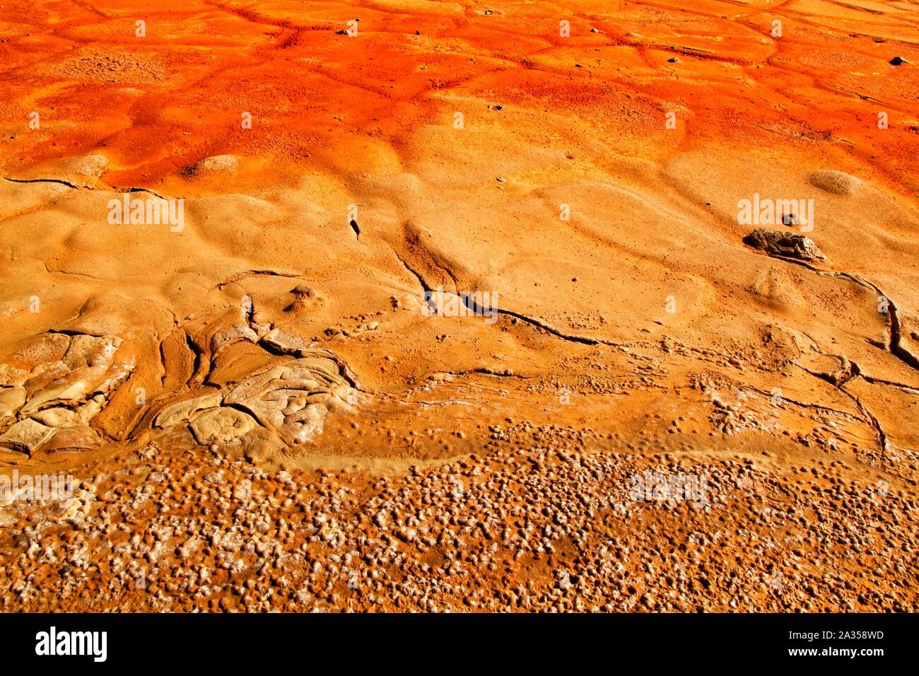 Colorful orange sediments deposited in a dry lake of an old abandoned ...