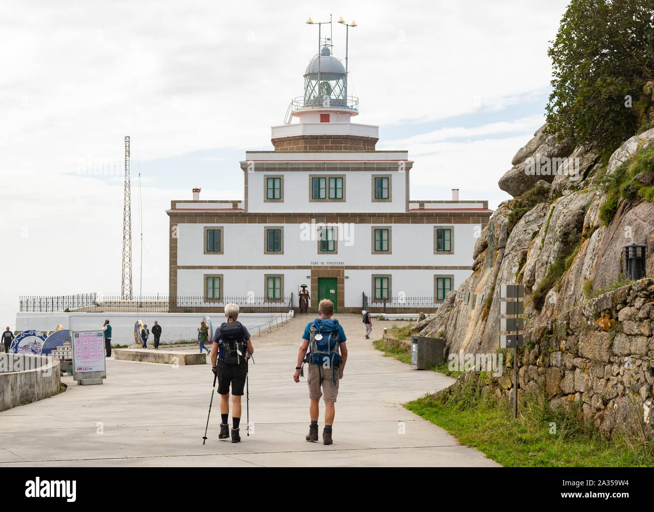 Walkers approaching Cape Finisterre Lighthouse at the end of the Camino ...