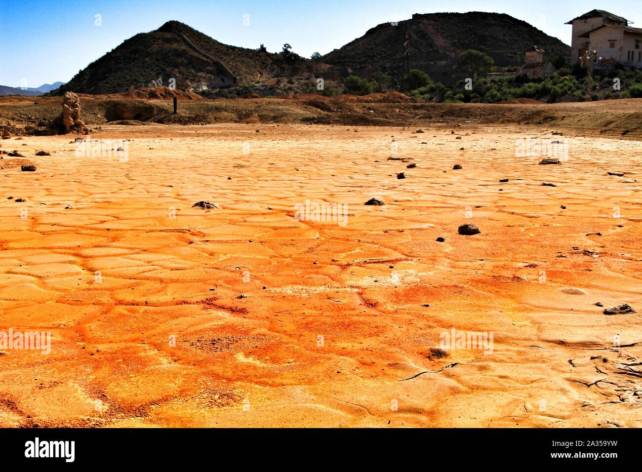 Colorful orange sediments deposited in a dry lake of an old abandoned ...