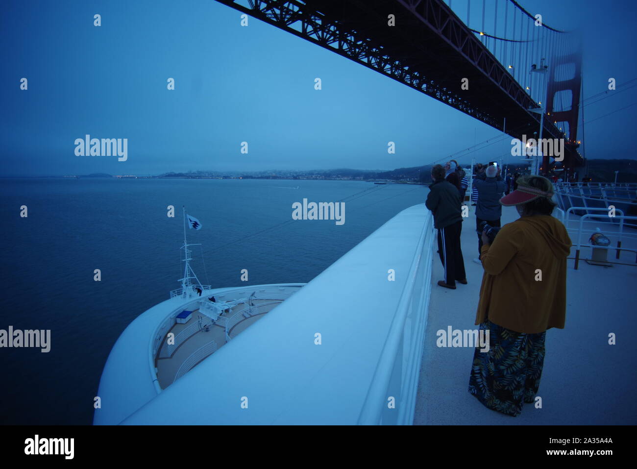 Cruise ship Grand Princess passing under the Golden Gate Bridge at dawn ...