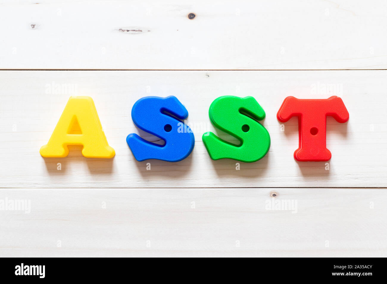 Letter block in word asst (abbreviation of assistant) on white wood ...
