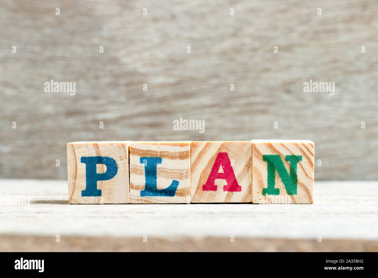 Letter block in word plan on wood background Stock Photo - Alamy