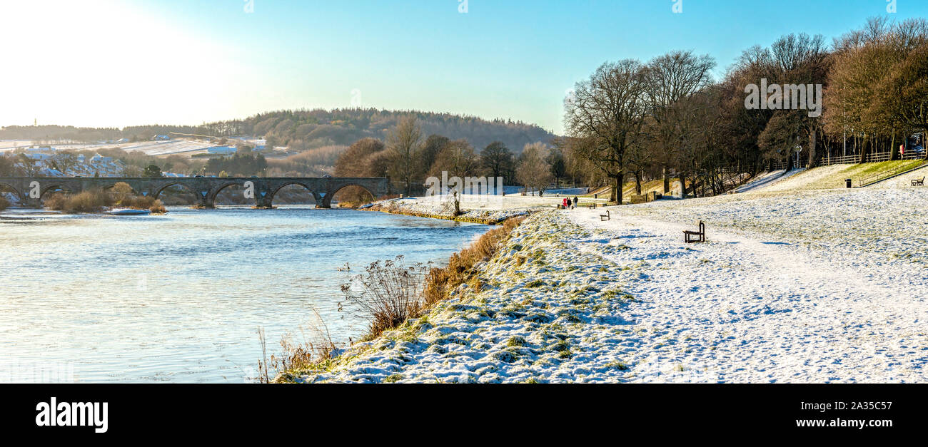 A Bridge of Dee and walking path along the river in winter season ...
