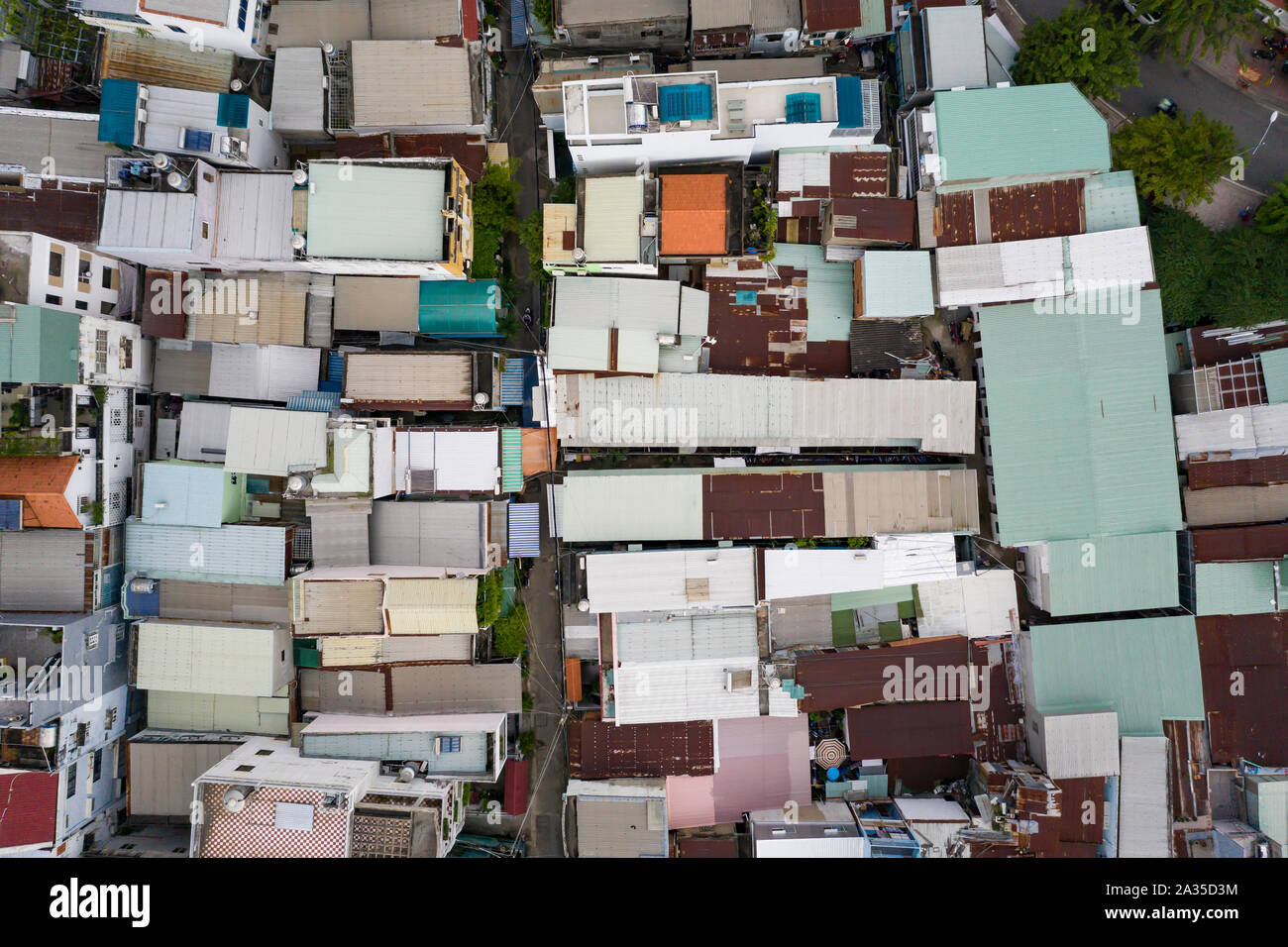 top down drone shot over rooftops in urban residential area of major ...