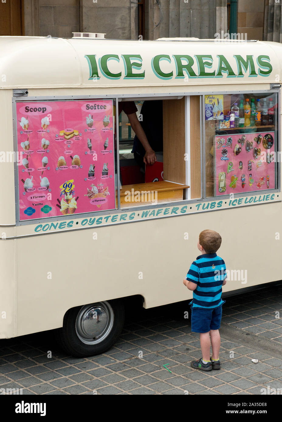 Young boy buying an ice cream Stock Photo - Alamy