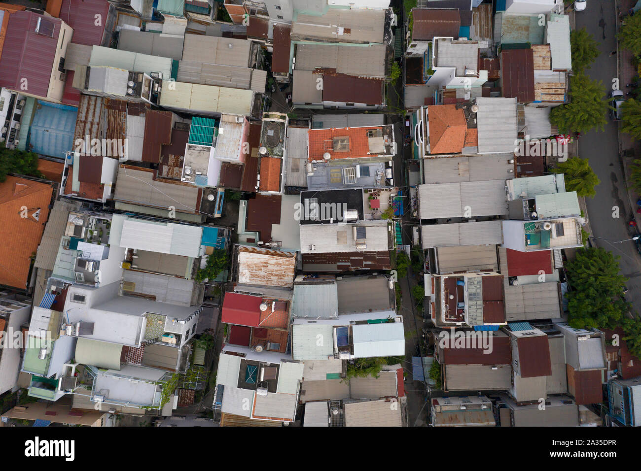 top down drone shot over rooftops in urban residential area of major ...