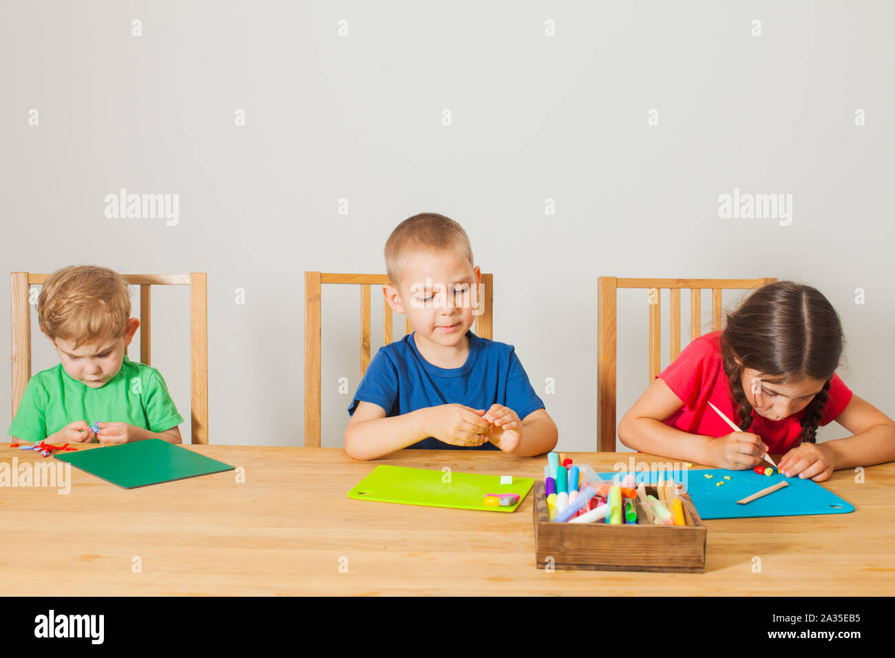 Creative kids molding with colorful modeling clay Stock Photo - Alamy