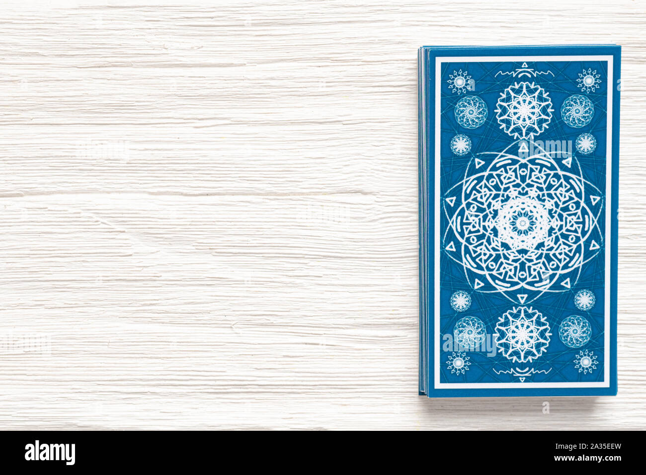 Blue tarot cards deck on white wooden table background with a copy ...