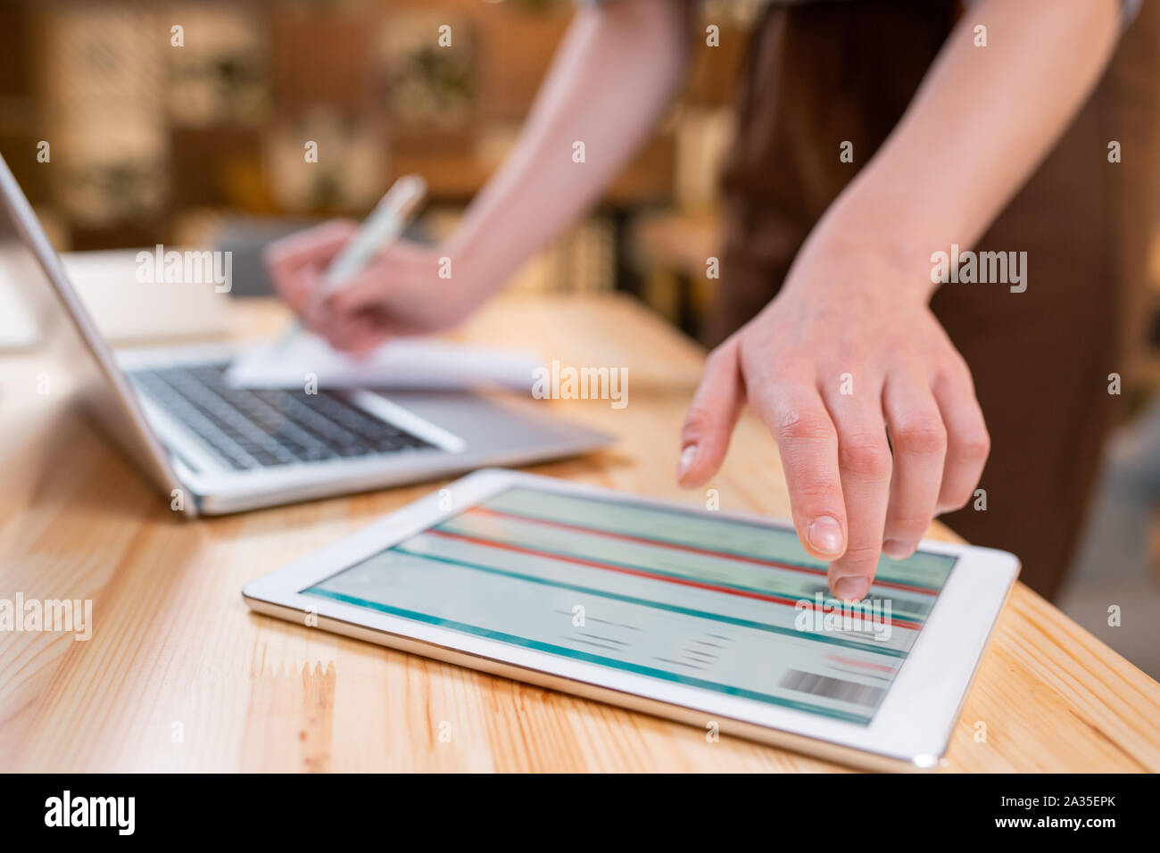 Hand of female employee pointing at electronic document on touchpad ...