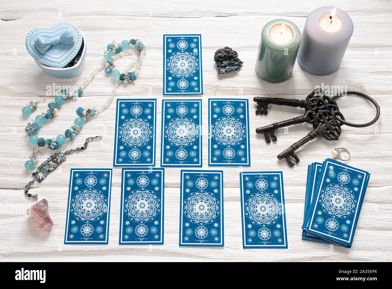Blue tarot cards and key to the fate on white wooden table background ...