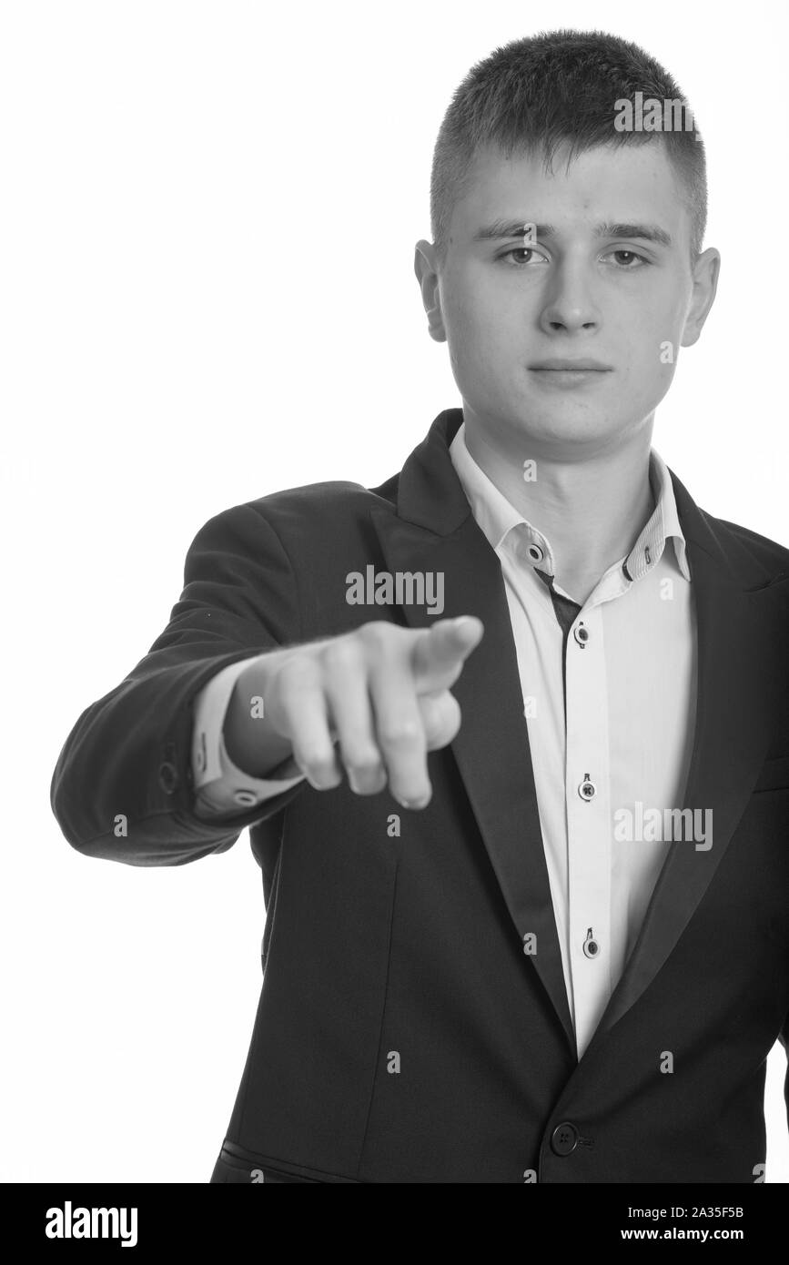 Studio shot of young businessman pointing finger at camera Stock Photo ...