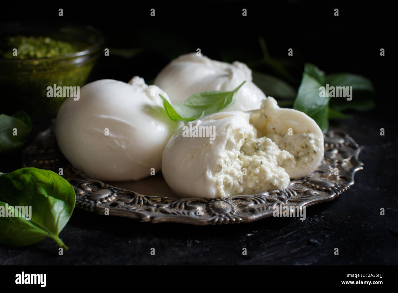 Italian mozzarella cheese stuffed with ricotta and persto close up ...