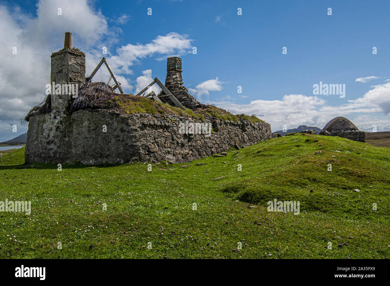 Abandoned croft on the shores of Loch Euphort, North Uist Western Isles ...