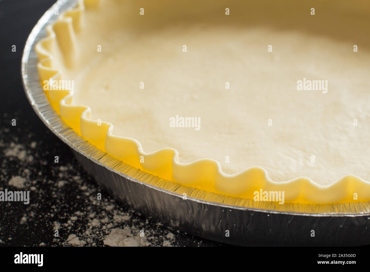 Pie base in an aluminium form on a dark background close up Stock Photo ...