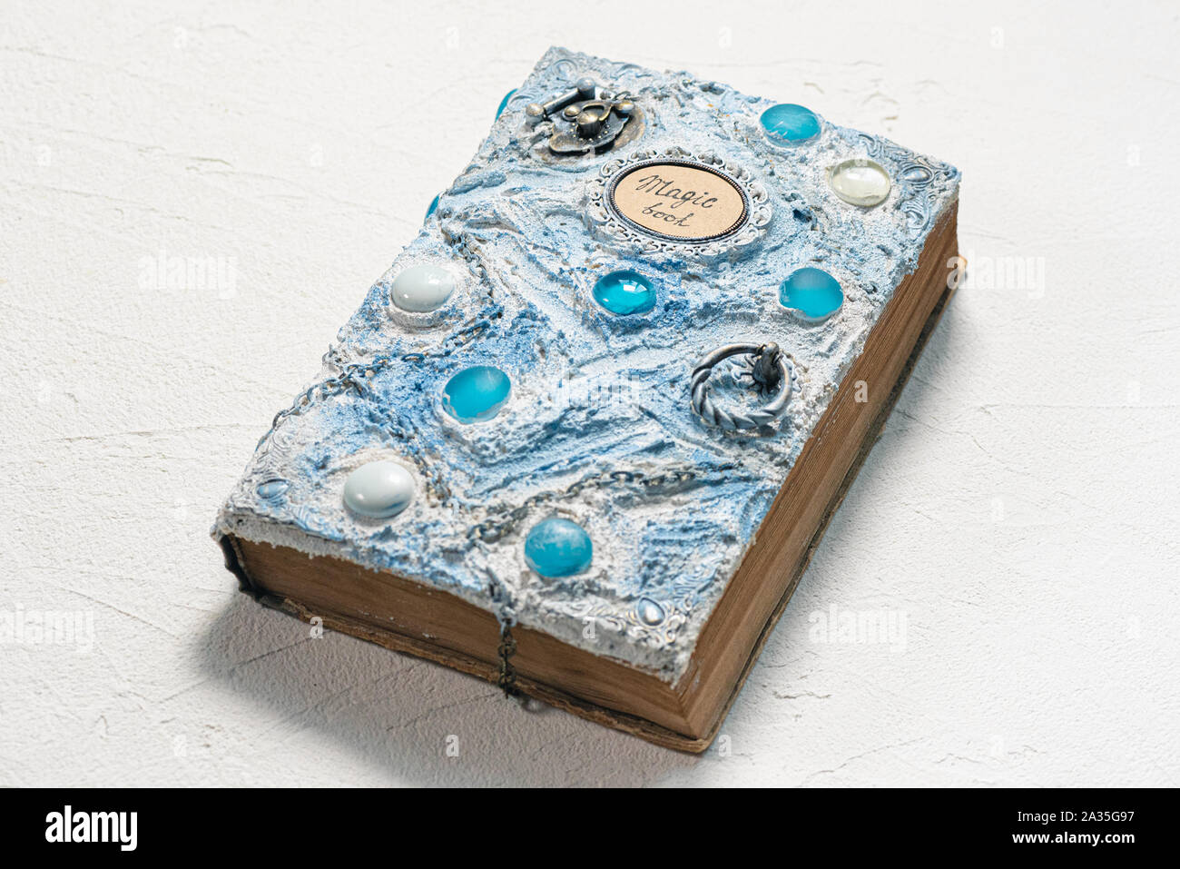 White magic book on a white background. Wizard table Stock Photo - Alamy