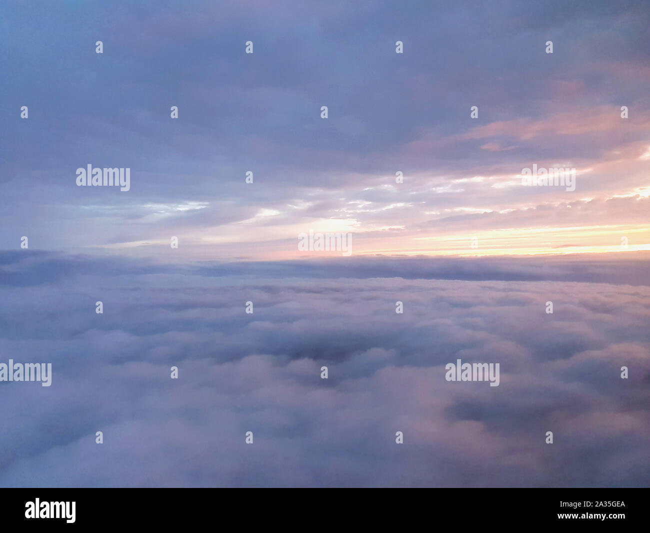 View from airplane window inside the clouds with colorful sunrise Stock ...