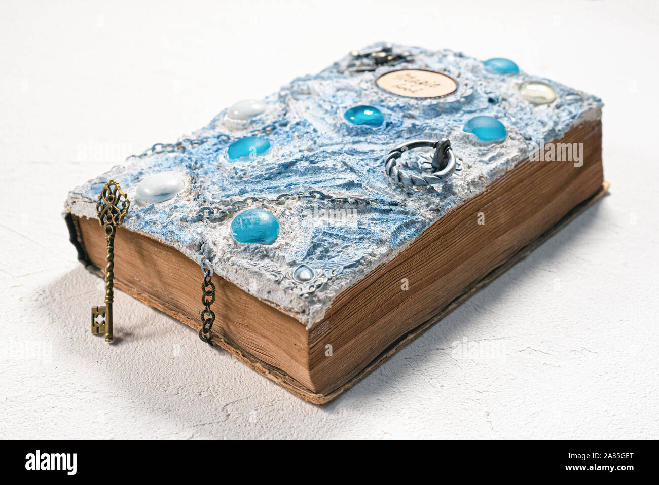White book of magic and key on the witch table background Stock Photo ...
