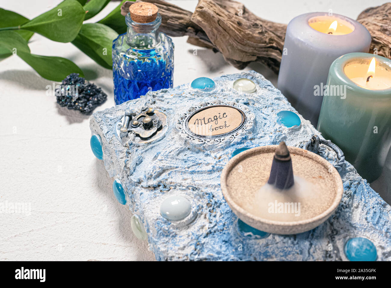 White book of magic on the witch table background Stock Photo - Alamy