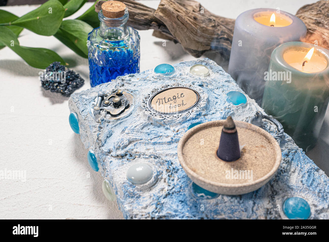 White magic book and magic potion bottle on a white background. Wizard ...