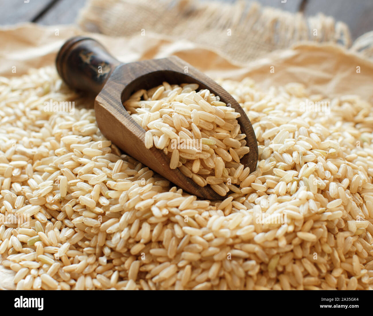 Pile of Brown rice with a wooden spoon close up Stock Photo - Alamy