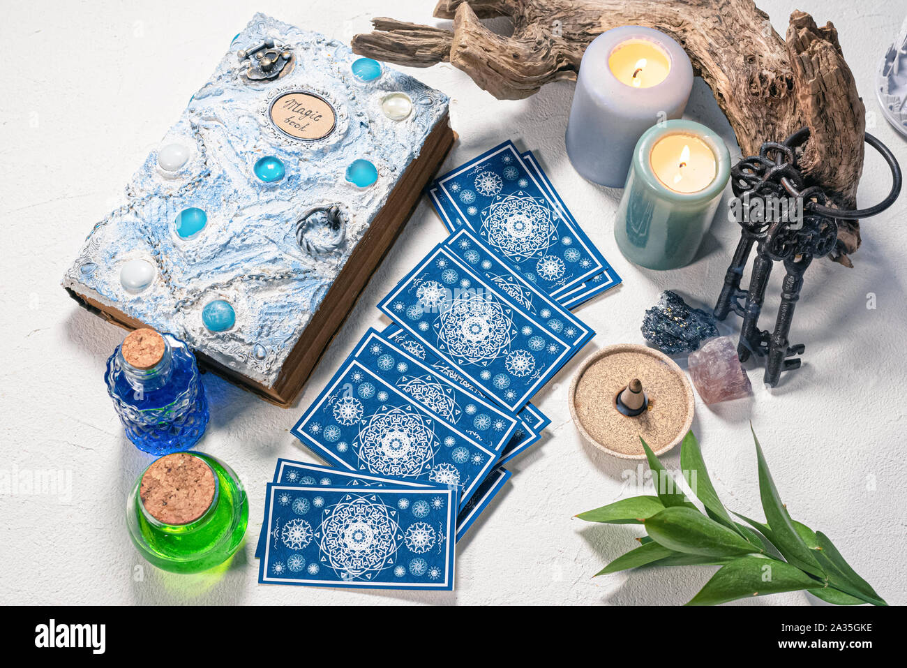Tarot cards and magic book and potion on the table Stock Photo - Alamy
