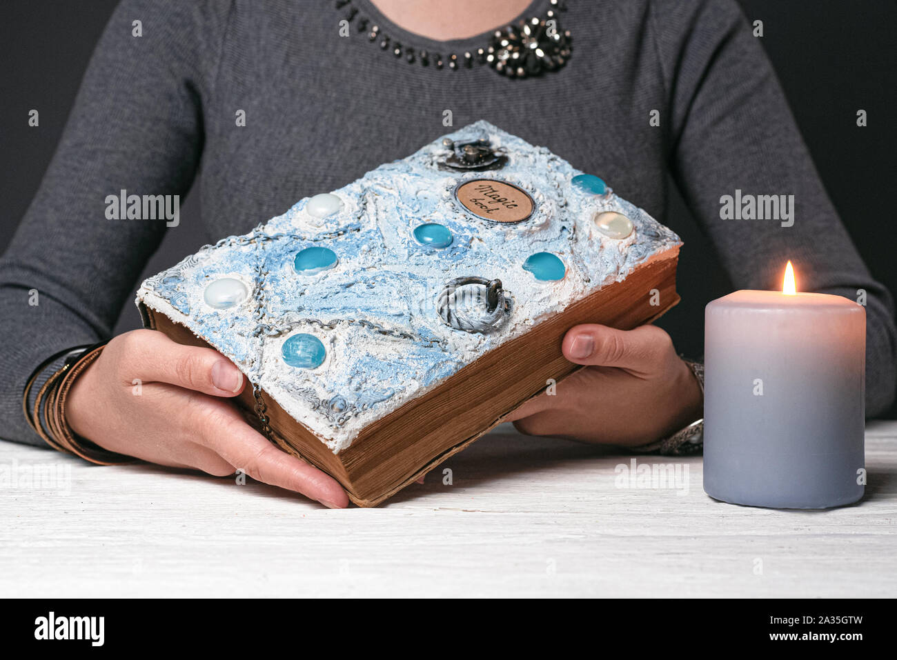 Magic book in a sorcerer hands close up Stock Photo - Alamy