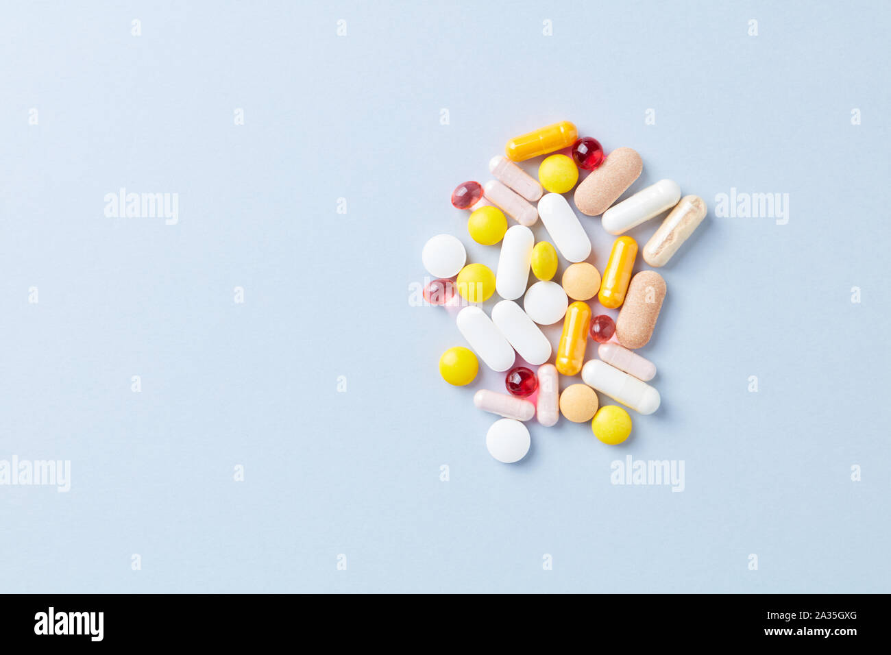 Multicolor vitamins and supplements on bright paper background. Top ...