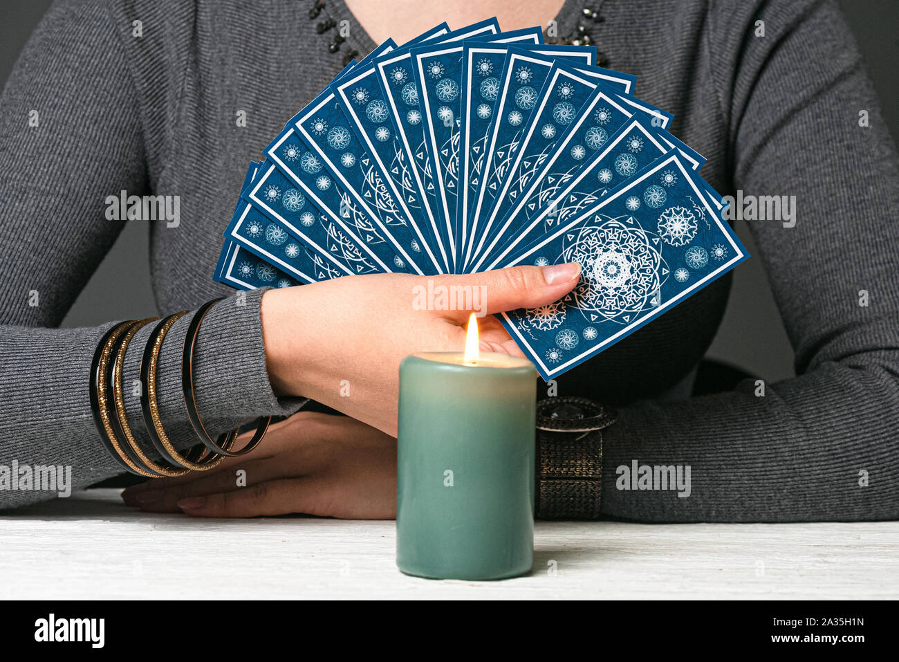 Fortune teller showing deck of tarot cards Stock Photo - Alamy