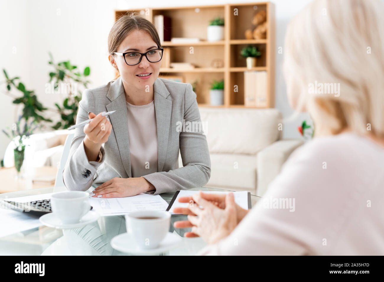 Smiling client sitting in hi-res stock photography and images - Alamy