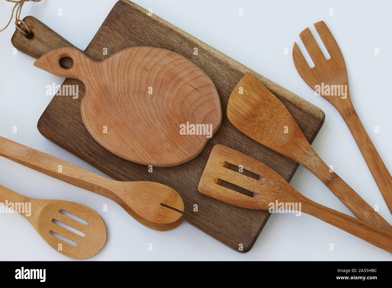 Wooden kitchen utensils on a white background, top view, horizontal ...