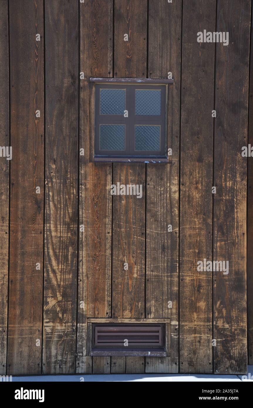 Wooden wall with small window Stock Photo - Alamy