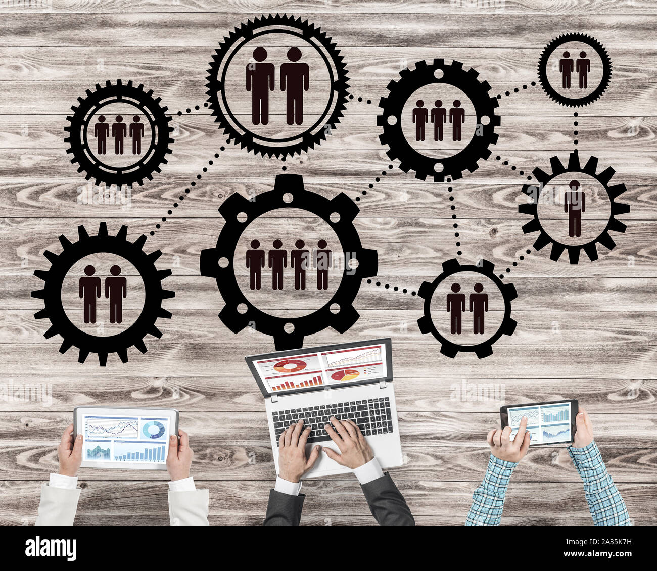 Group of three people with devices in hands working together as symbol ...