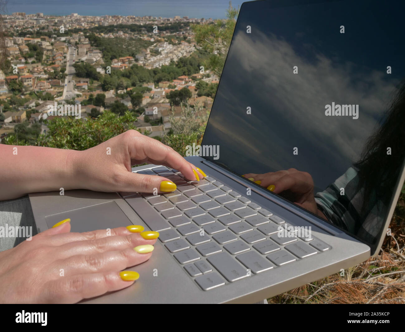 Female hands prints on a laptop, reflection in the monitor, against the ...